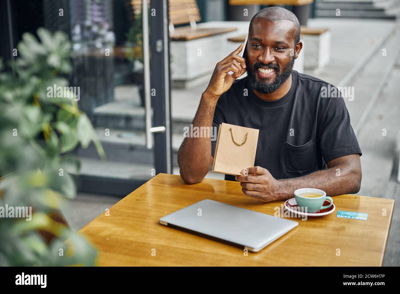 Man having friendly phone talk in the cafe Stock Photo - Alamy