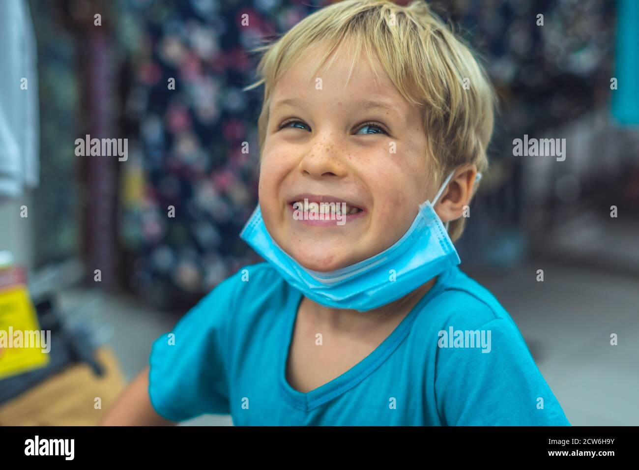 Close portrait cute smiling blue eyed freckled blond boy artistic ...
