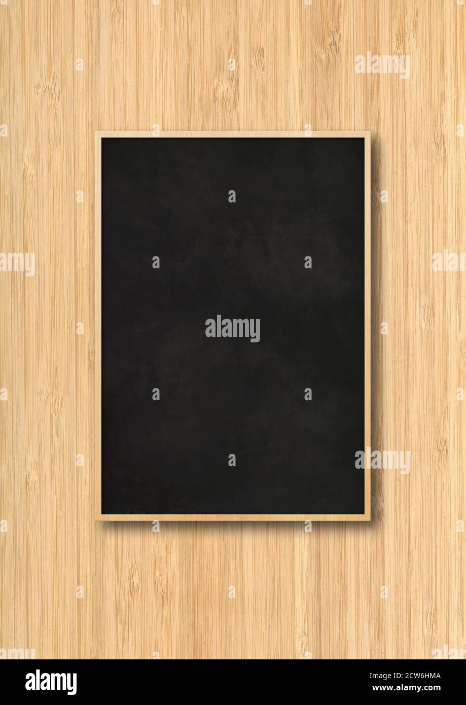 Traditional black board isolated on a wooden background. Blank vertical ...