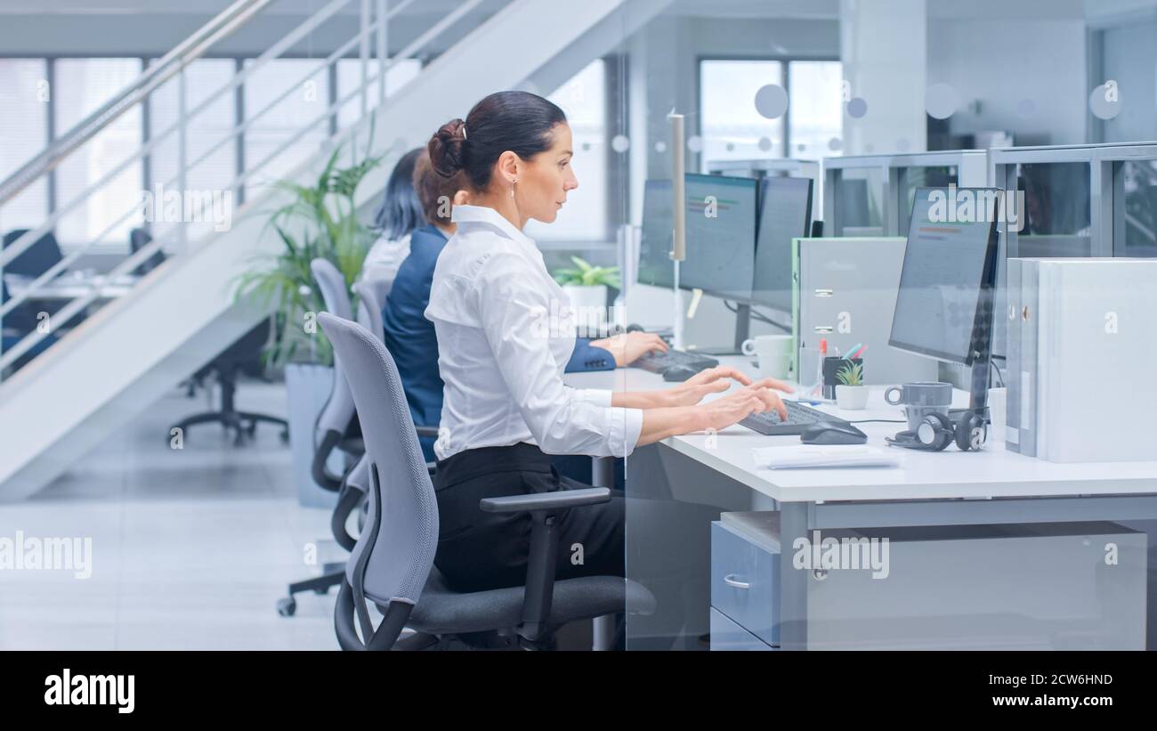 Beautiful Female Manager Works on a Desktop Computer. Diverse and ...