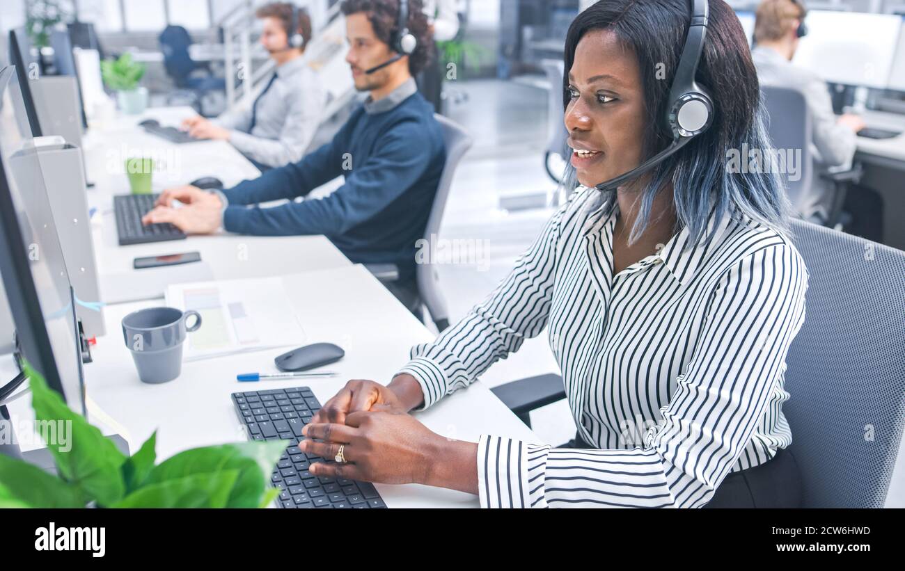 Beautiful Young Female Customer Service Operator Working in a Busy ...