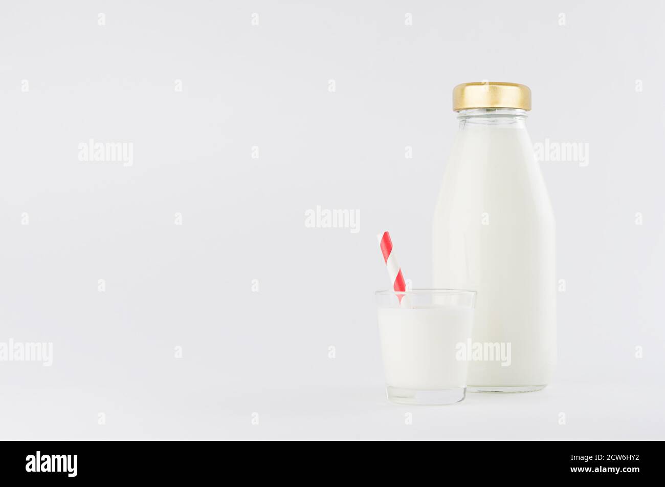 White milk, dairy product in glass bottle mock up with glass, red ...
