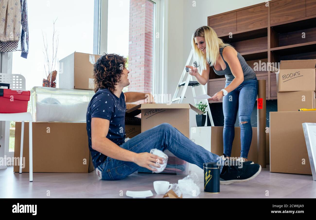 Couple unpacking moving boxes Stock Photo - Alamy