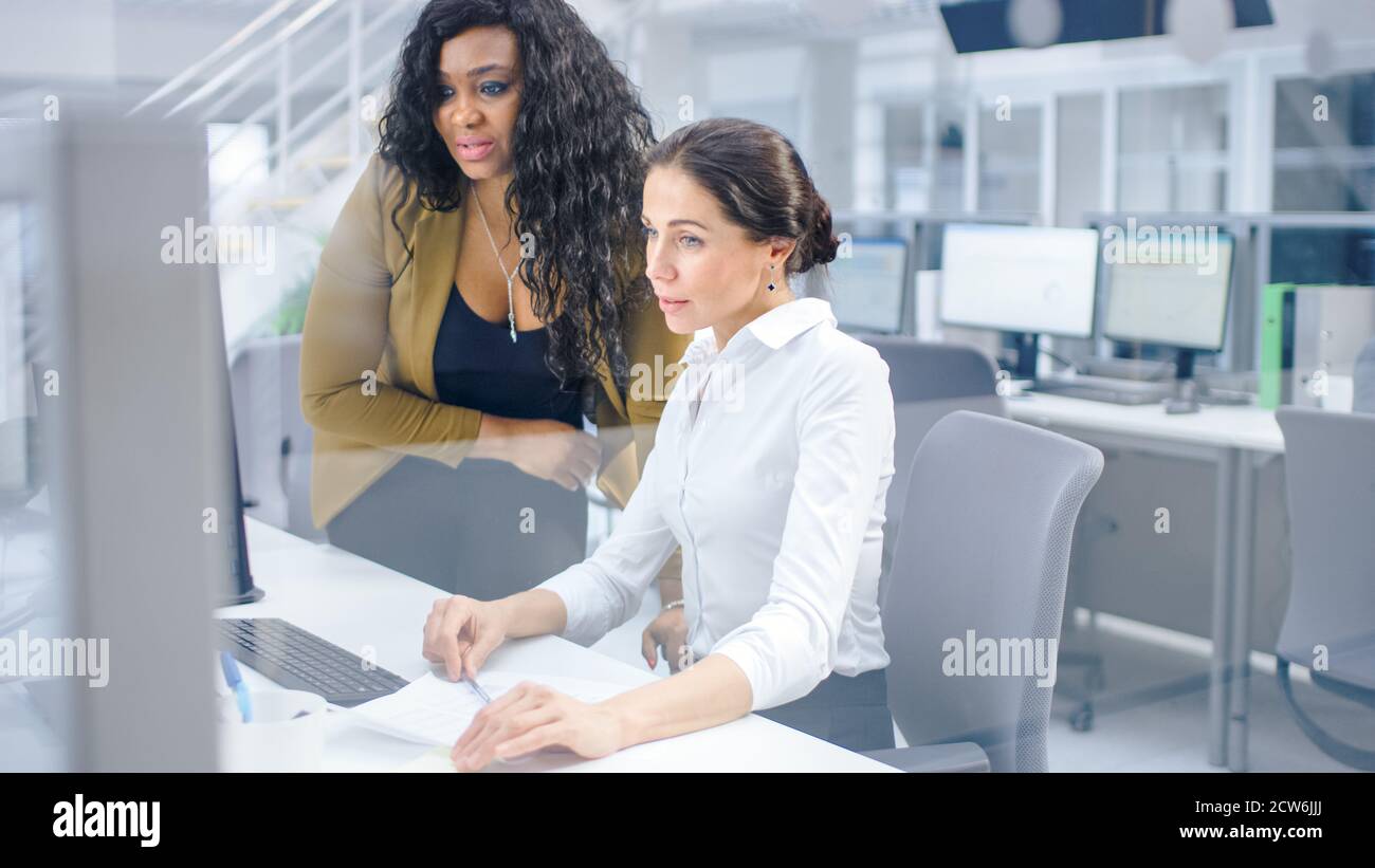 In Bright Modern Office: Beautiful Businesswoman Sitting and Working at ...