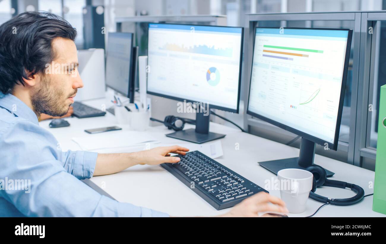 Over the Shoulder Shot of Motivated Office Worker Working on Desktop ...