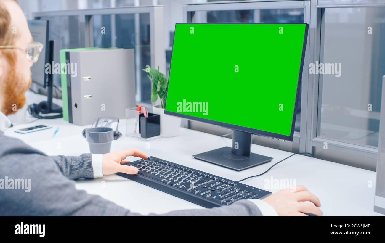 Over the Shoulder Shot of Motivated Office Worker Using Green Mock-up ...