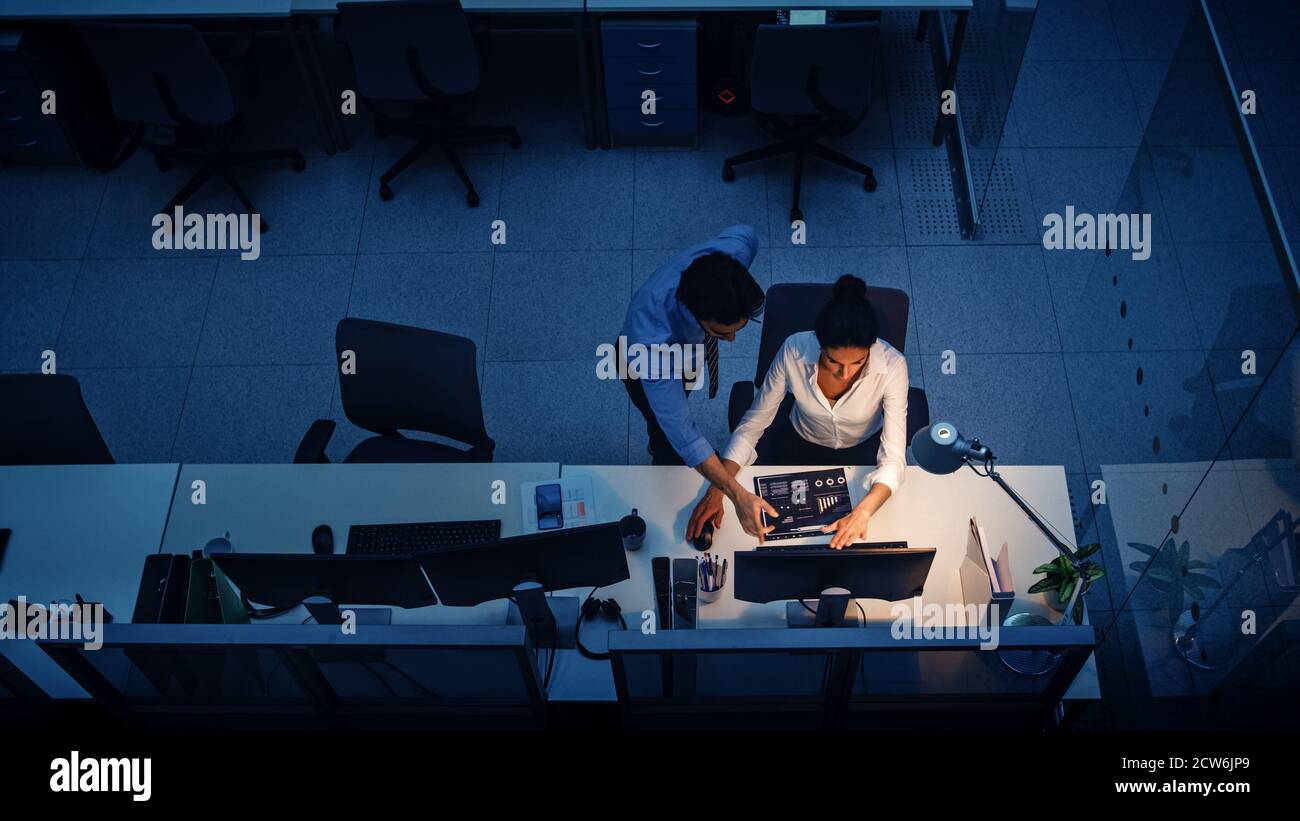 Working Late at Night in the Office: Businesswoman and Businessman ...