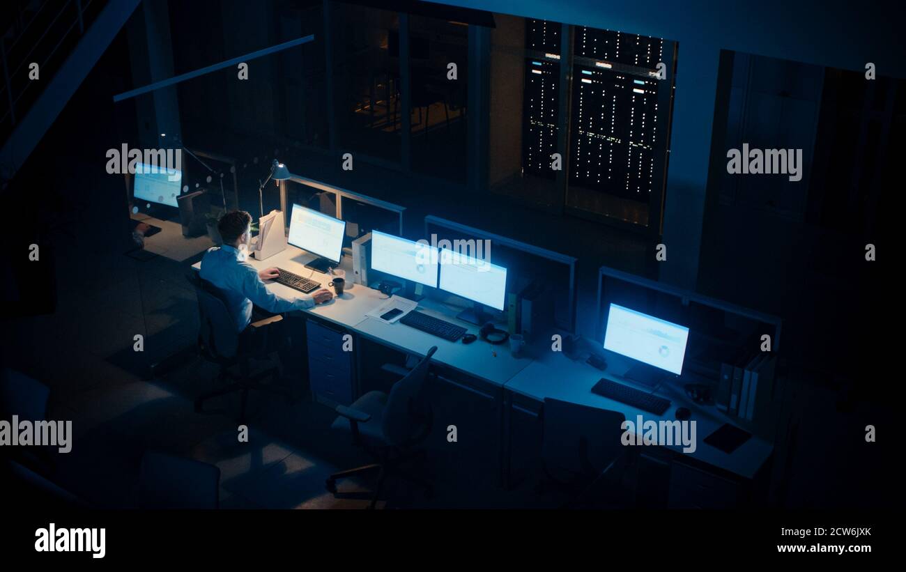 Working Late at Night in the Office: Businessman Using Desktop Computer ...