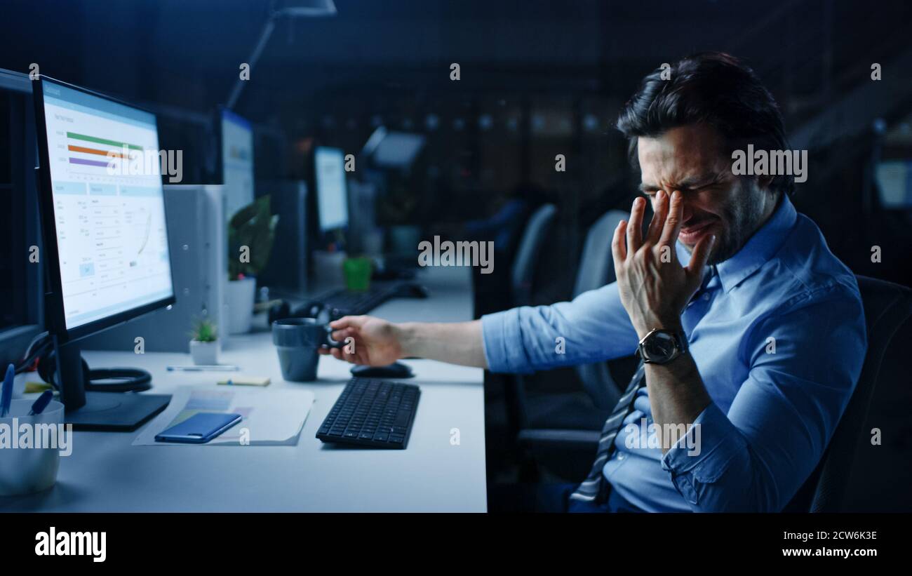 In the Office at Night Overworked Tired Office Worker Uses Desktop ...