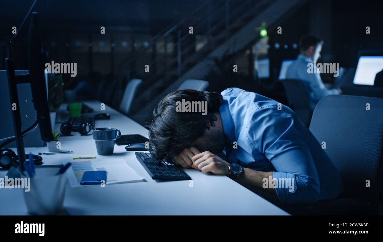 In the Office at Night Overworked Tired Office Worker Uses Desktop ...