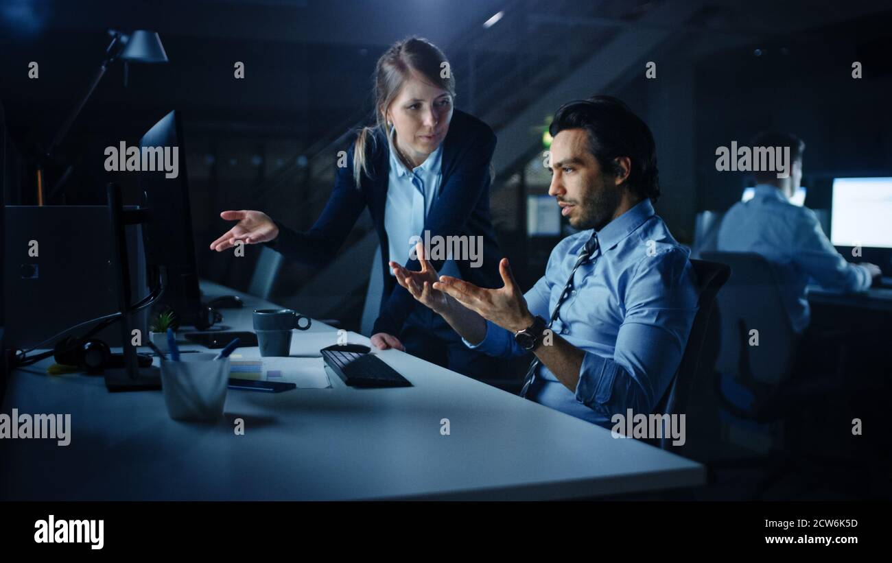 Confident Businessman Uses Desktop Computer, His Female Project Manager ...