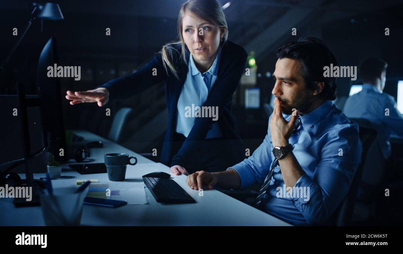 Confident Businessman Uses Desktop Computer, His Female Project Manager ...