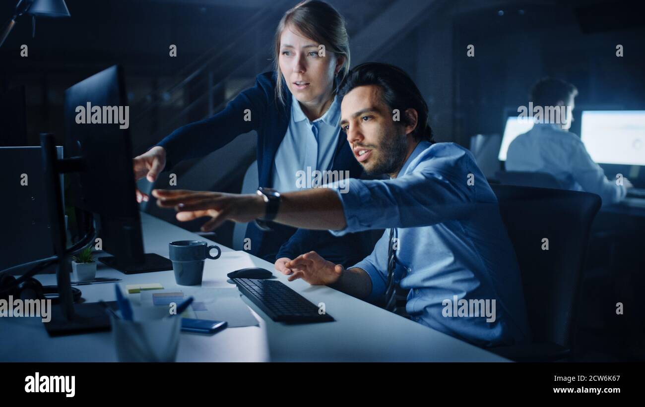 Confident Businessman Uses Desktop Computer, His Female Project Manager ...