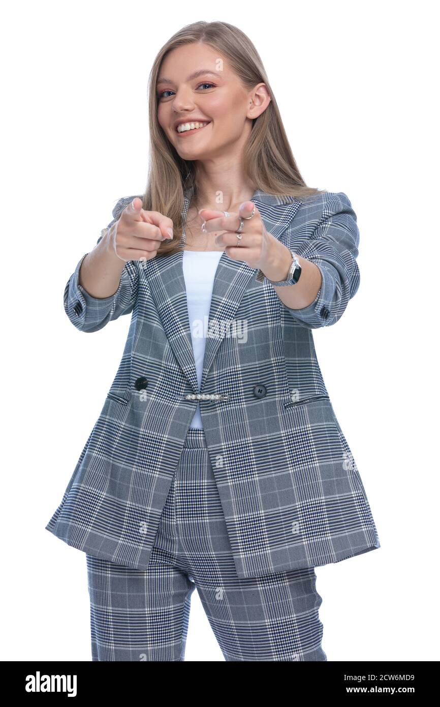 young fashion model in blue checkered suit smilling, pointing fingers ...