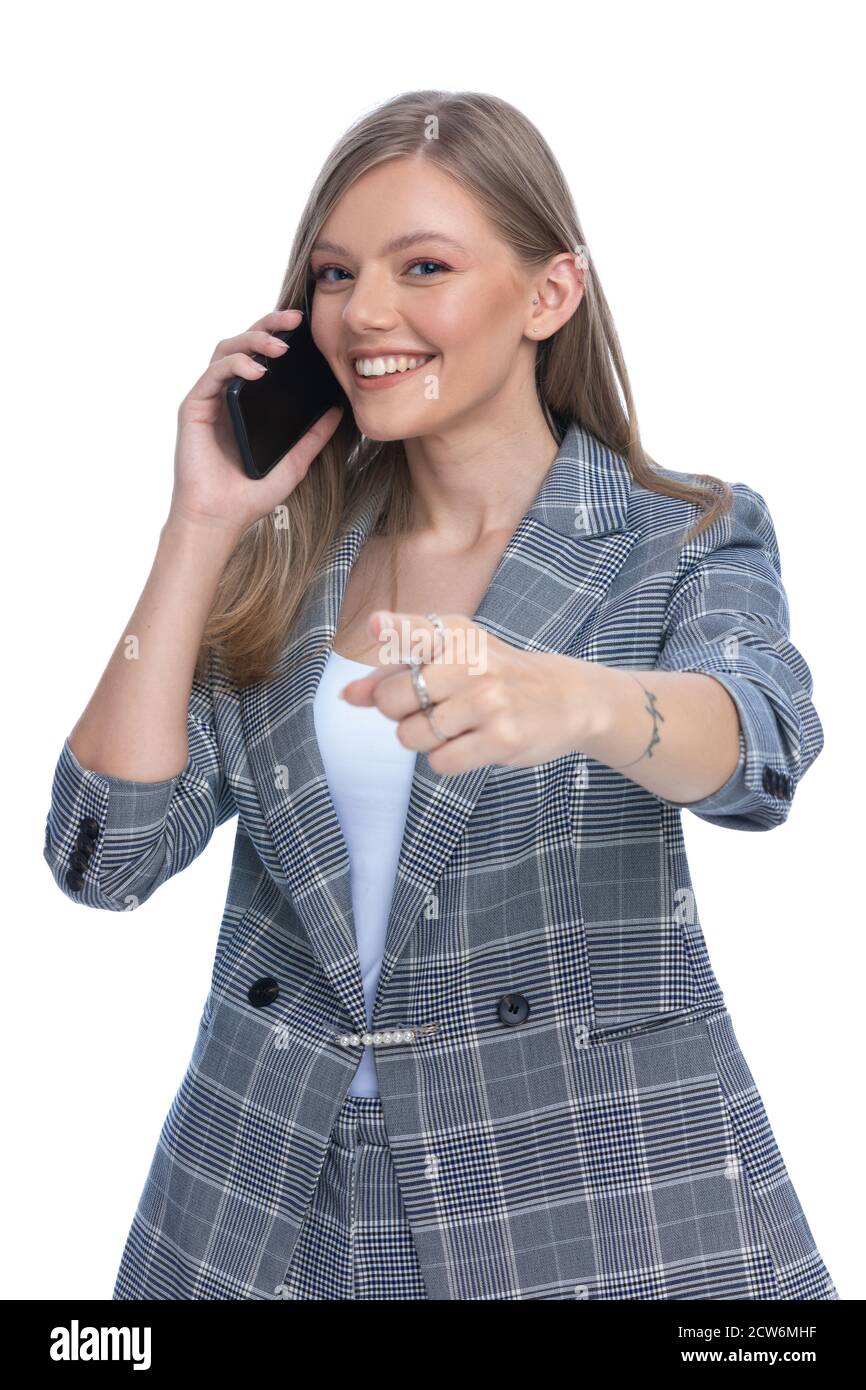 young businesswoman in blue checkered suit talking on the phone and ...