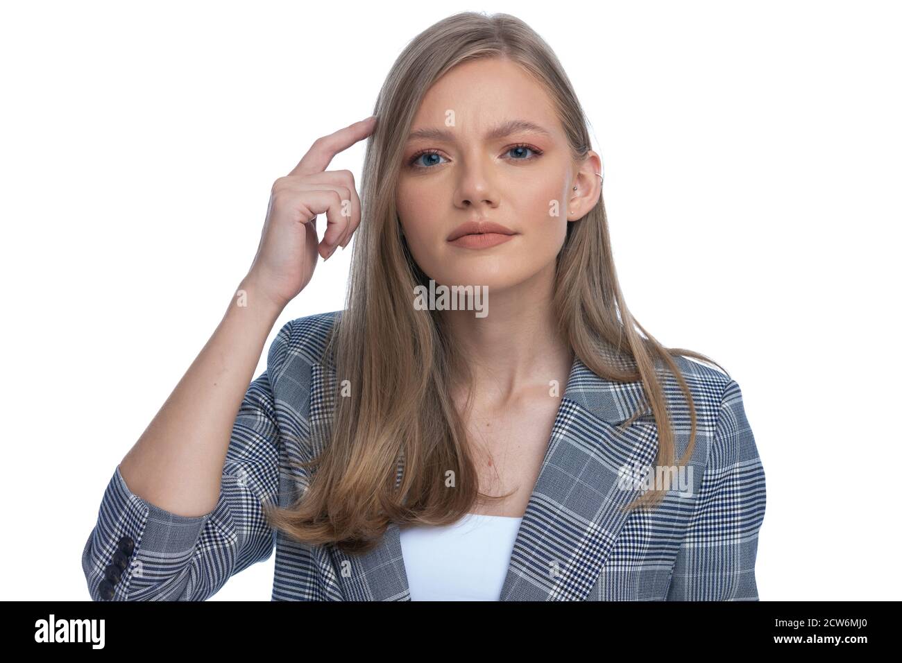 young businesswoman in blue checkered suit pointing finger to head and ...