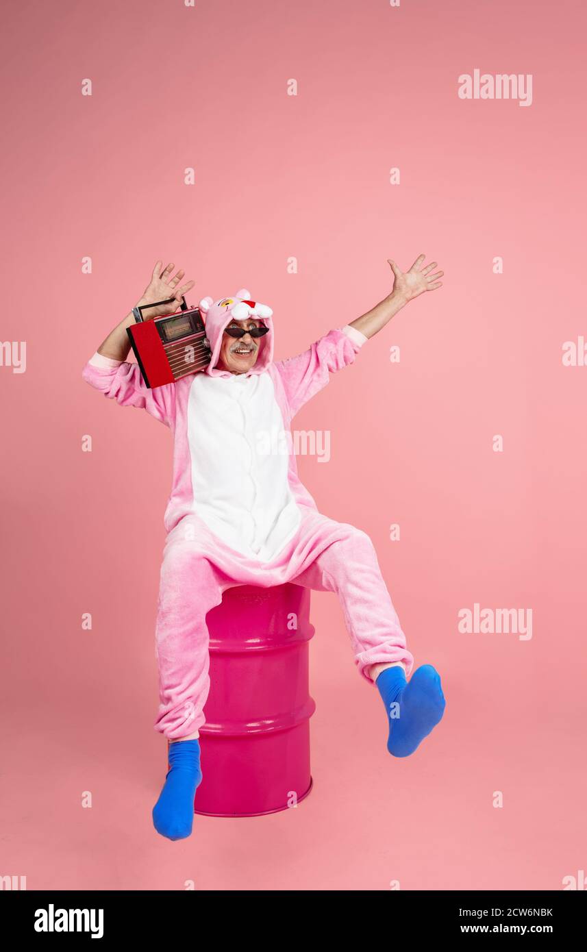 Listening to music using turntable. Portrait of senior hipster man in stylish attire isolated on ...