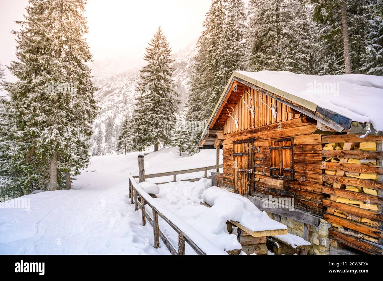 Wooden house in winter mountain landscape. Cottage / Hut in snowy ...