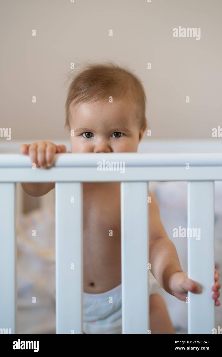 8 month old baby girl standing in the crib Stock Photo - Alamy