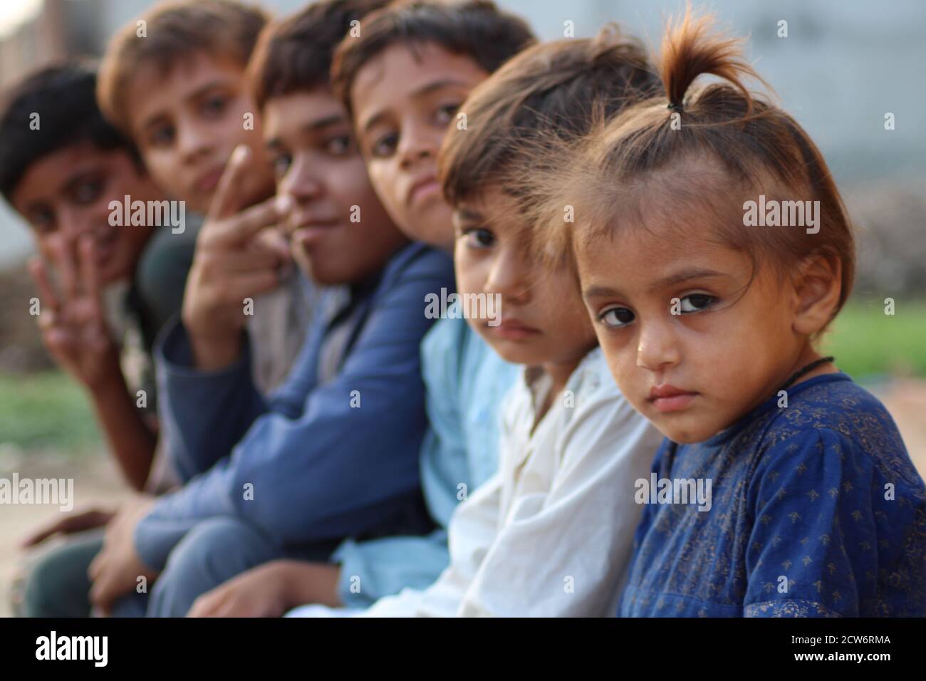 group of children sitting in row Stock Photo - Alamy