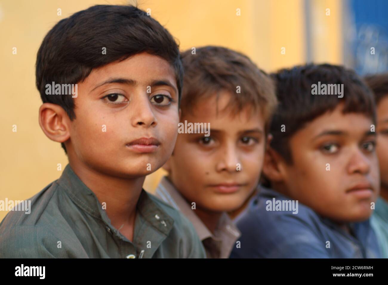 group of children sitting in row Stock Photo - Alamy