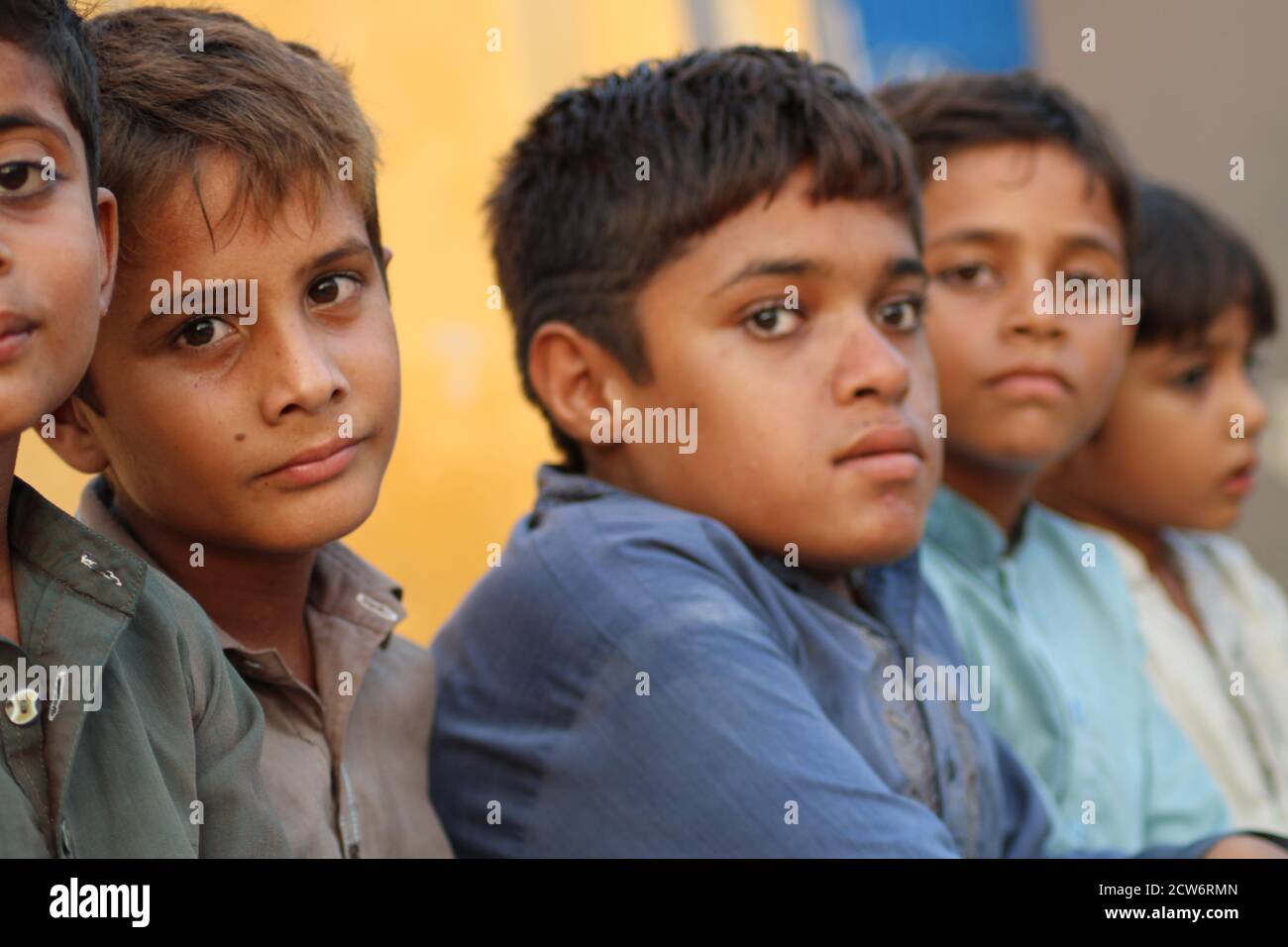 Group Of Children Sitting In Row Stock Photo Alamy