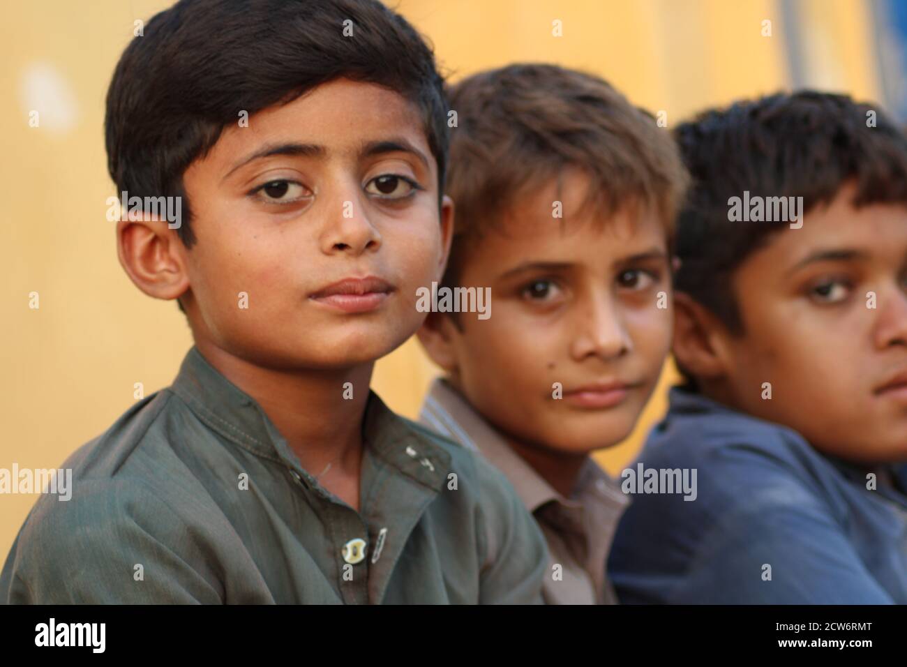 group of children sitting in row Stock Photo - Alamy