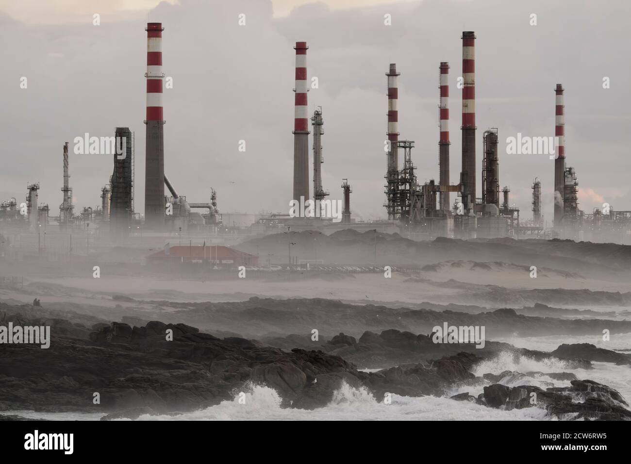 Oil refinery by the sea in a winter foggy evening Stock Photo - Alamy