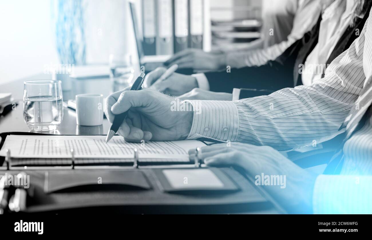 Business people taking notes during a training; light effect Stock ...