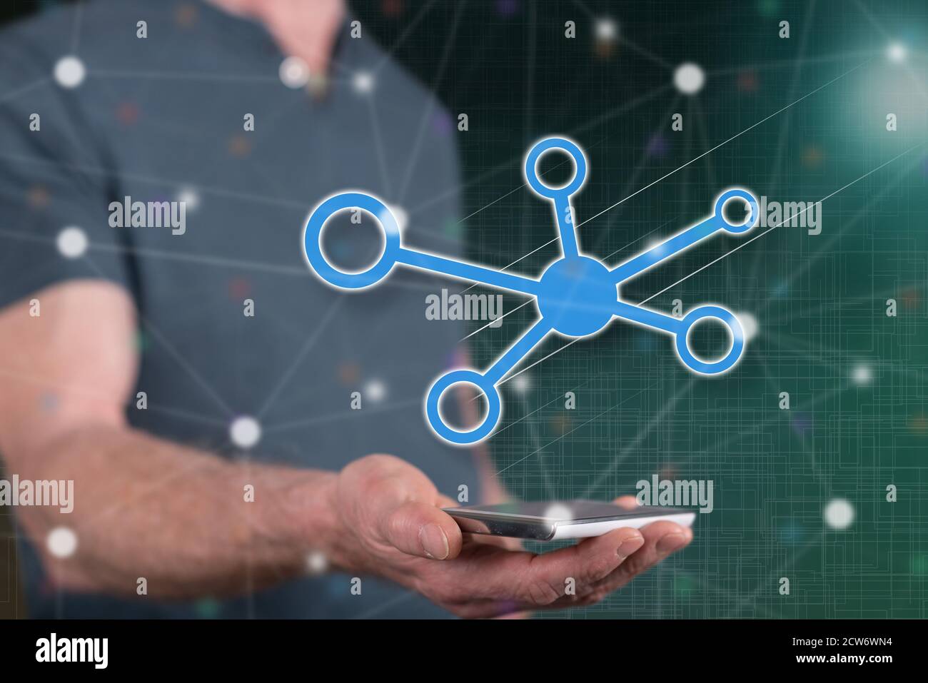 Network concept above a smartphone held by a man in background Stock ...