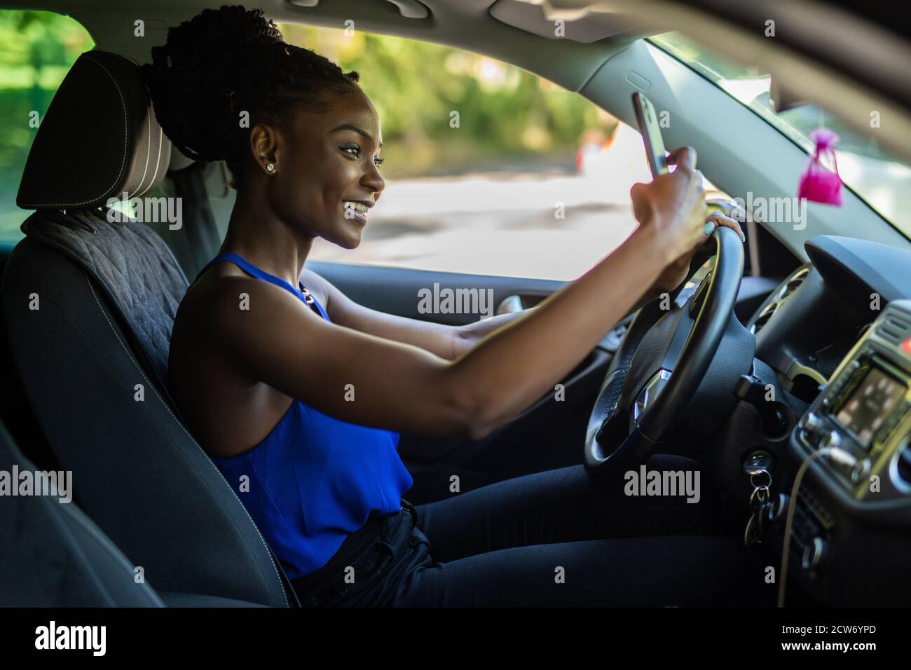 Young black woman driver seated in her car Stock Photo - Alamy