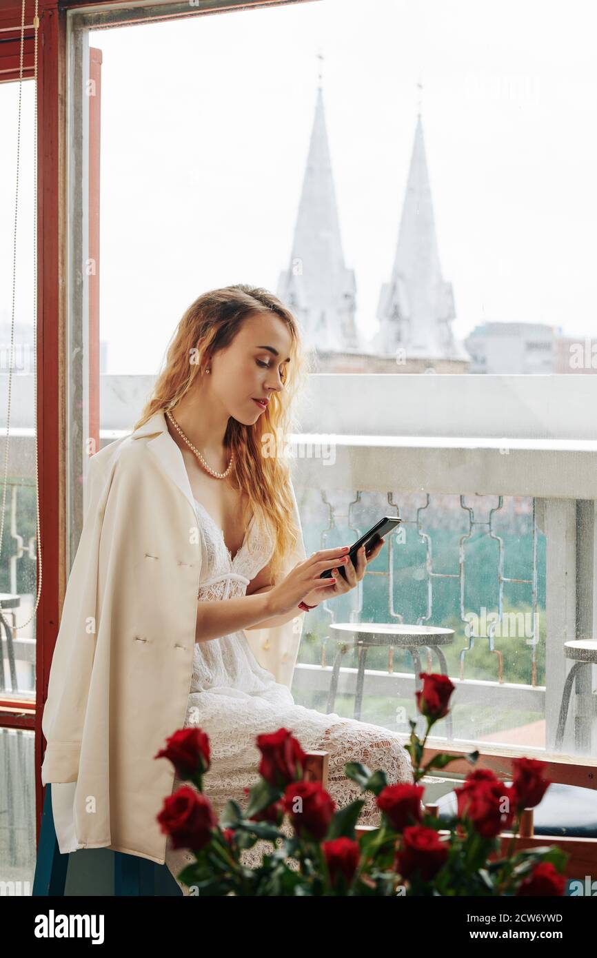 Elegant woman checking text messages Stock Photo - Alamy