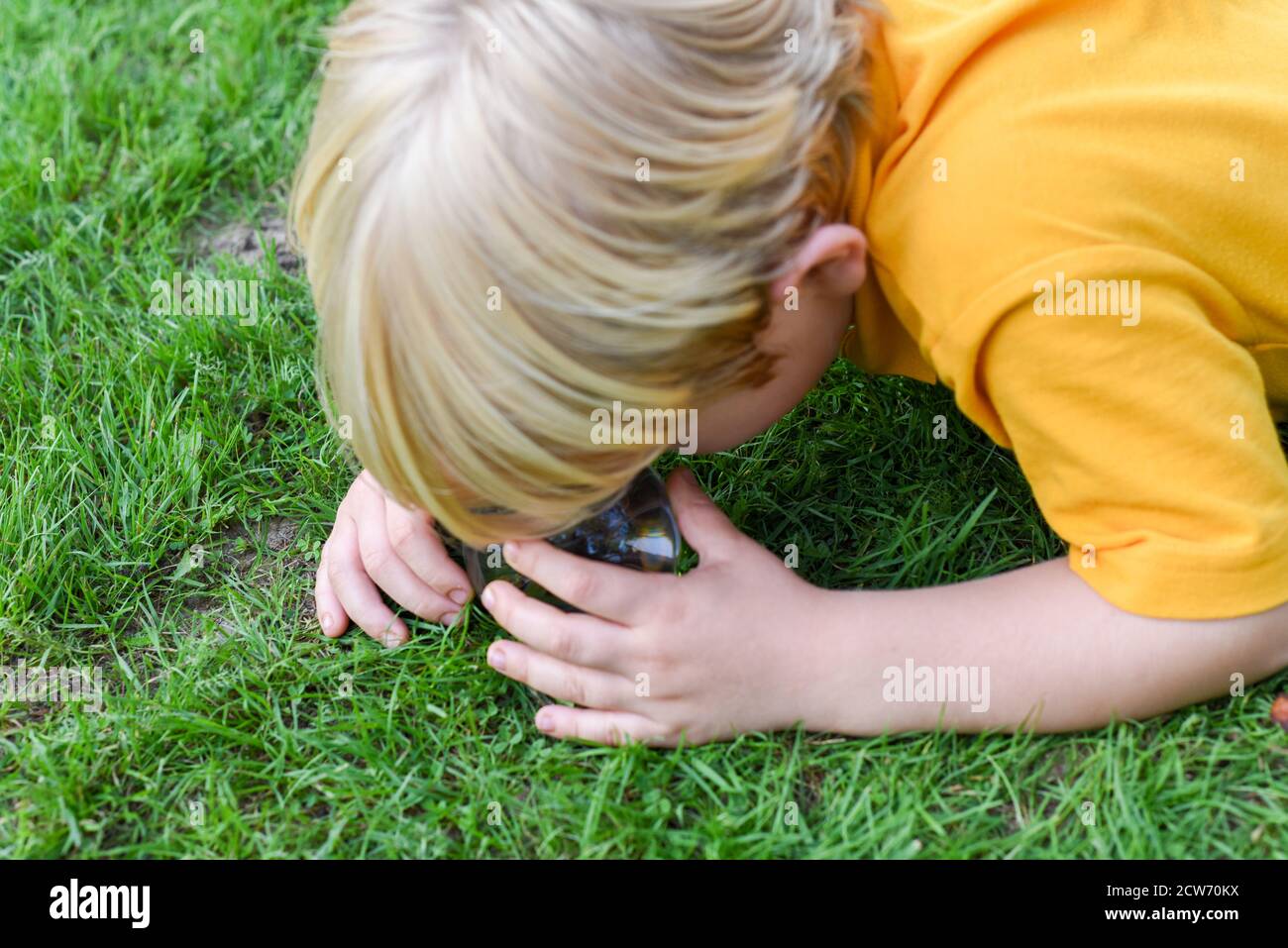 Child learning about nature outside through play and exploring the ...