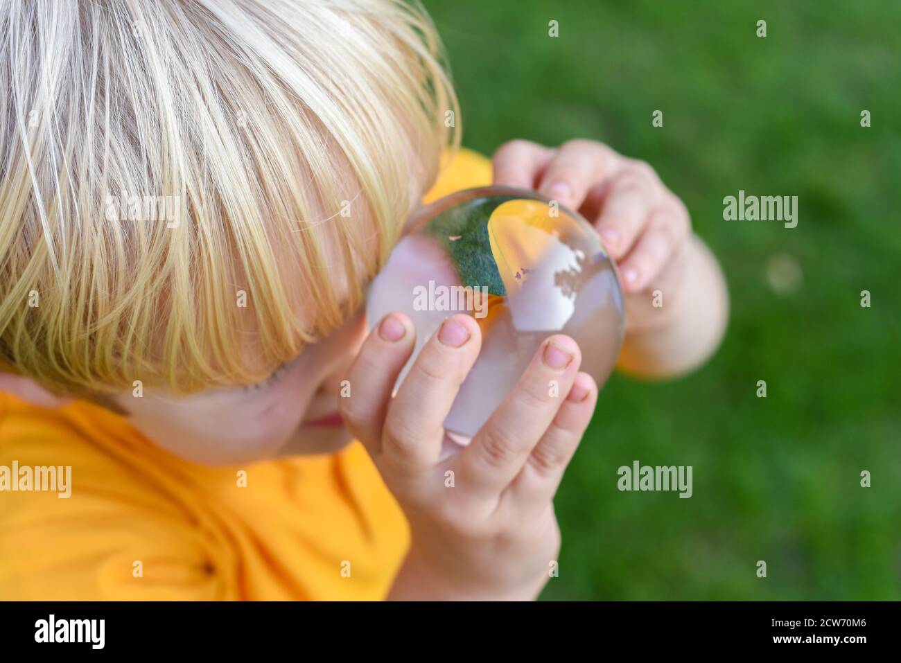 Child learning about nature outside through play and exploring the ...