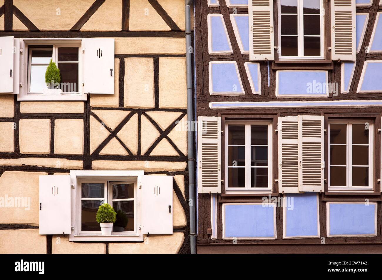 Old fashioned half timbered facades, cute small windows with shutters ...