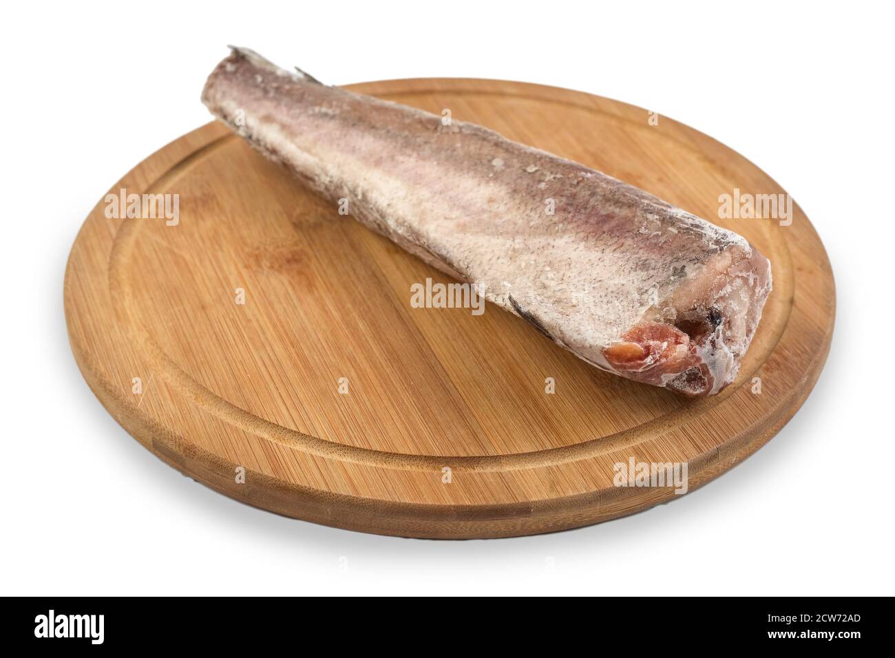 Frozen hake fish lies on the board, isolated on white background. Side ...