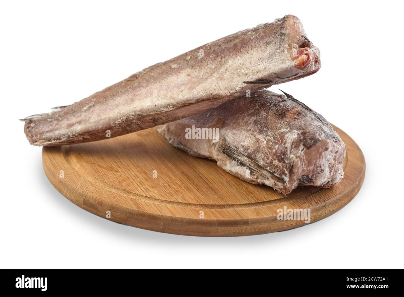 Frozen hake fish lies on the board, isolated on white background. Side ...