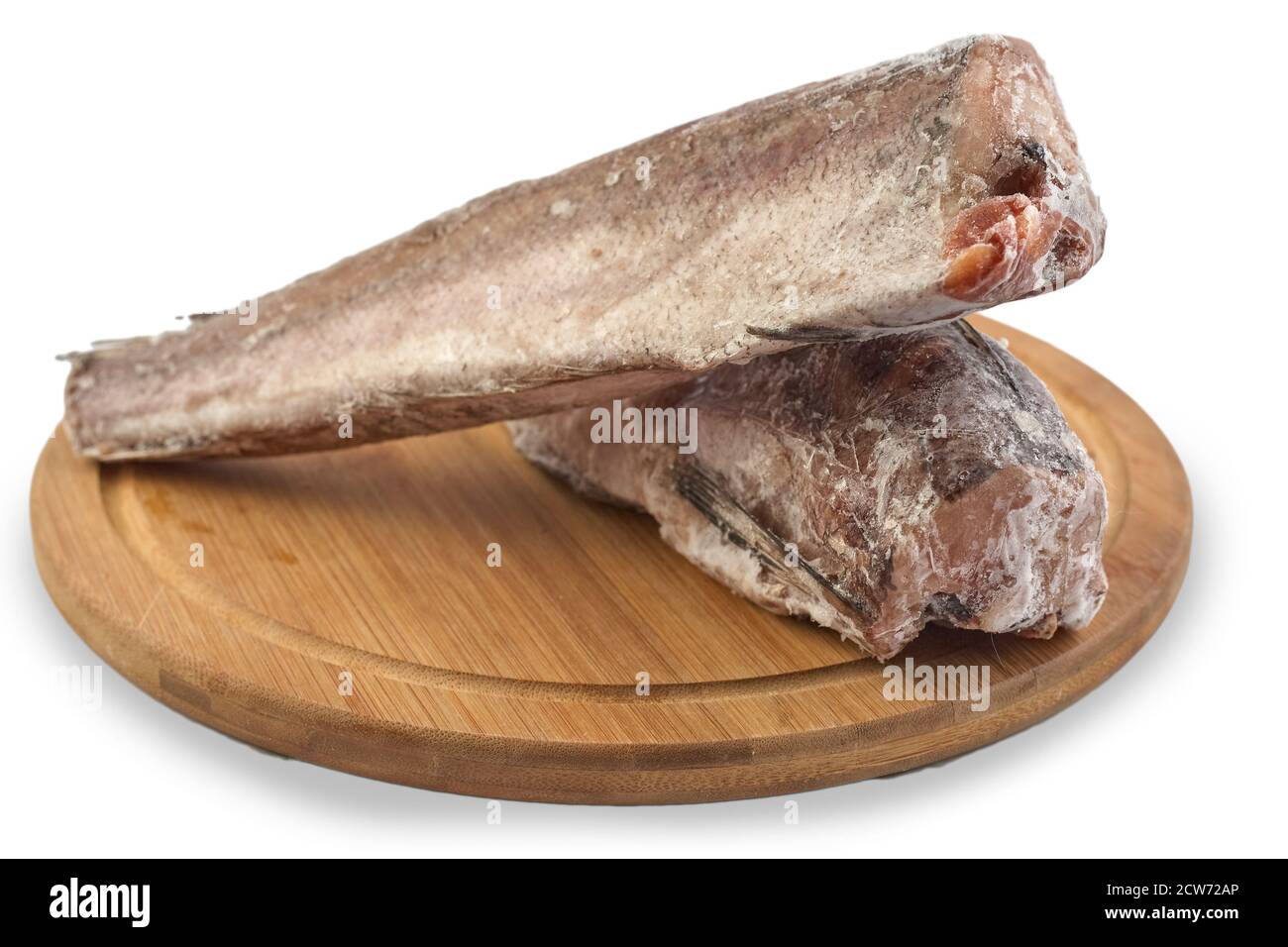 Frozen hake fish lies on the board, isolated on white background. Side ...