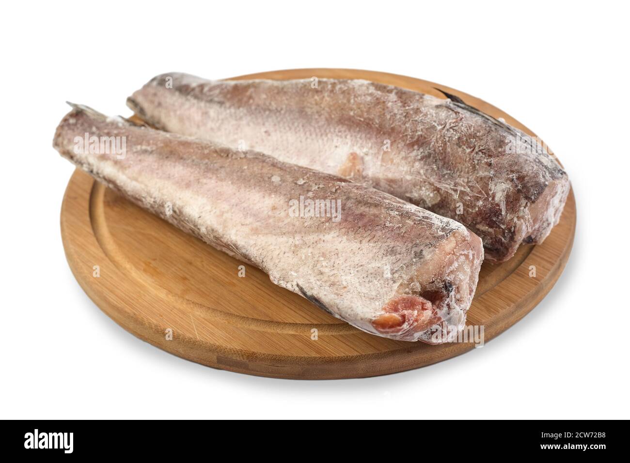 Frozen hake fish lies on the board, isolated on white background. Side ...