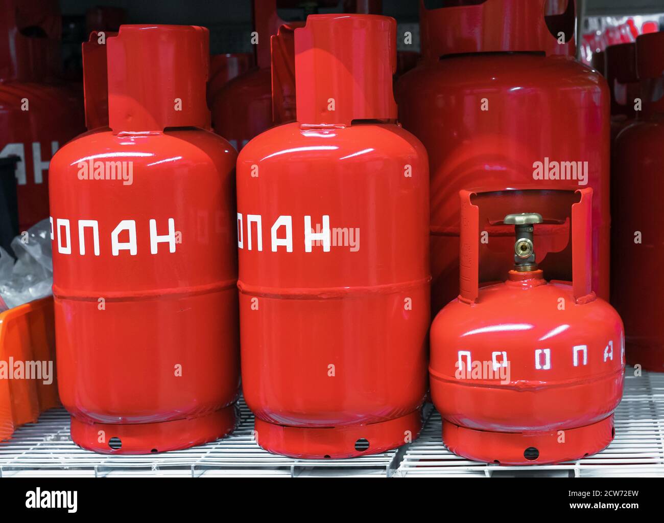 Red cylinders with propane gas. Cylinders with an inscription in ...