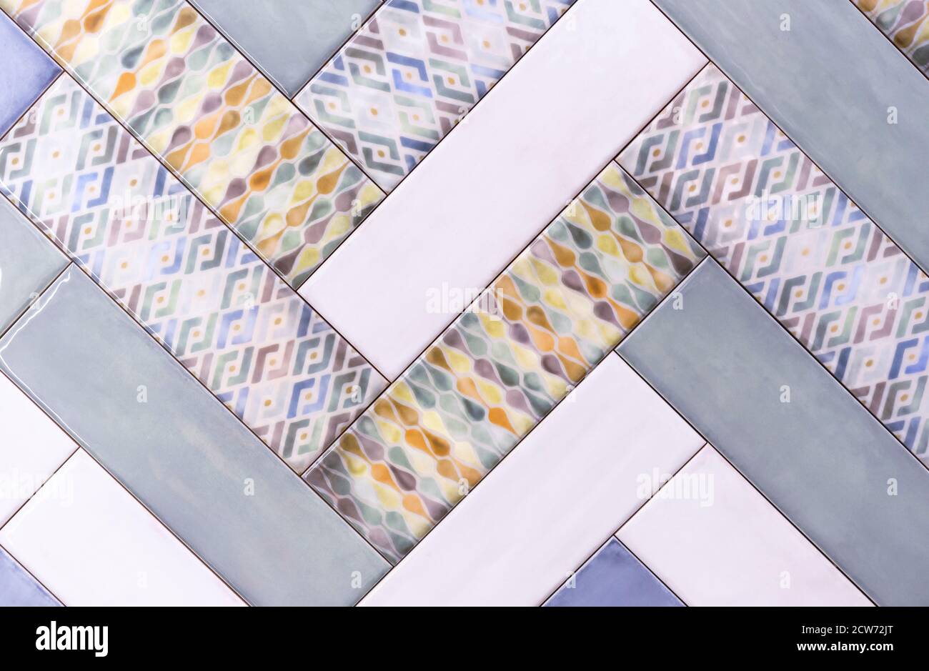 Multicolored ceramic tiles are arranged in a herringbone pattern Stock ...
