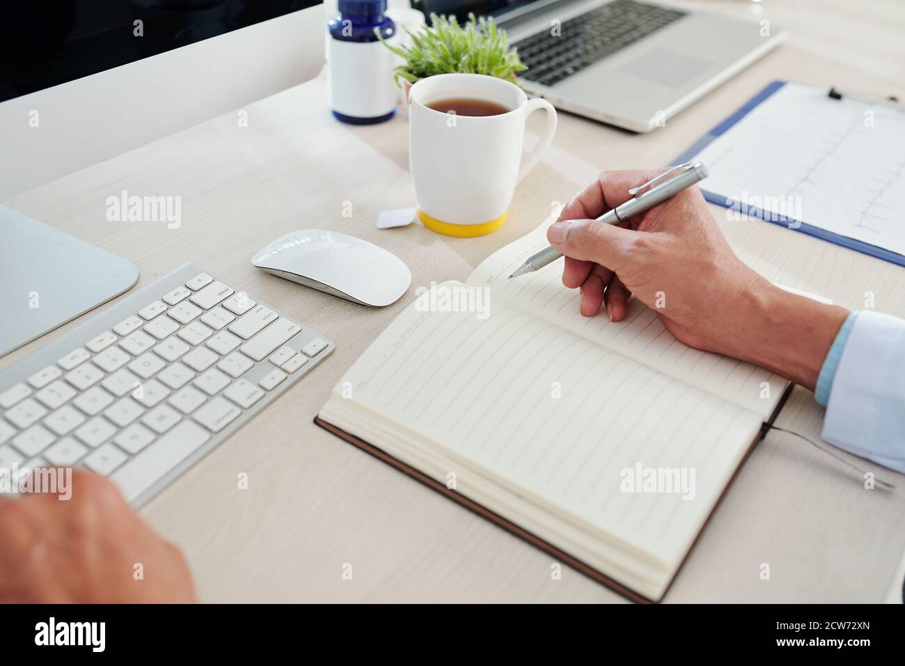 Cardiologist writing in planner Stock Photo - Alamy