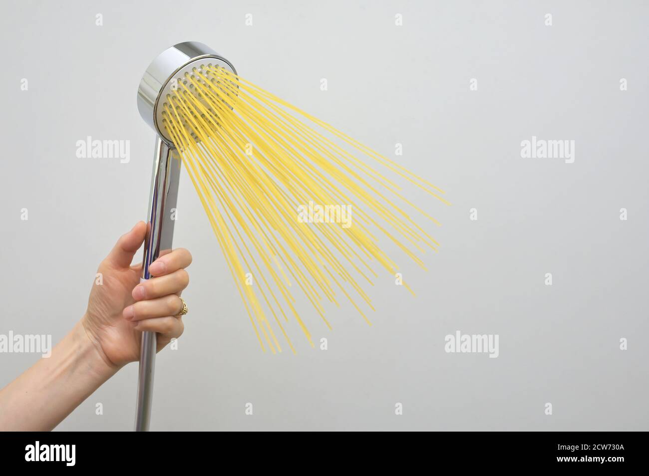 Abstract Woman Hand With Silver Shower and Pasta Spaghetti like Water ...