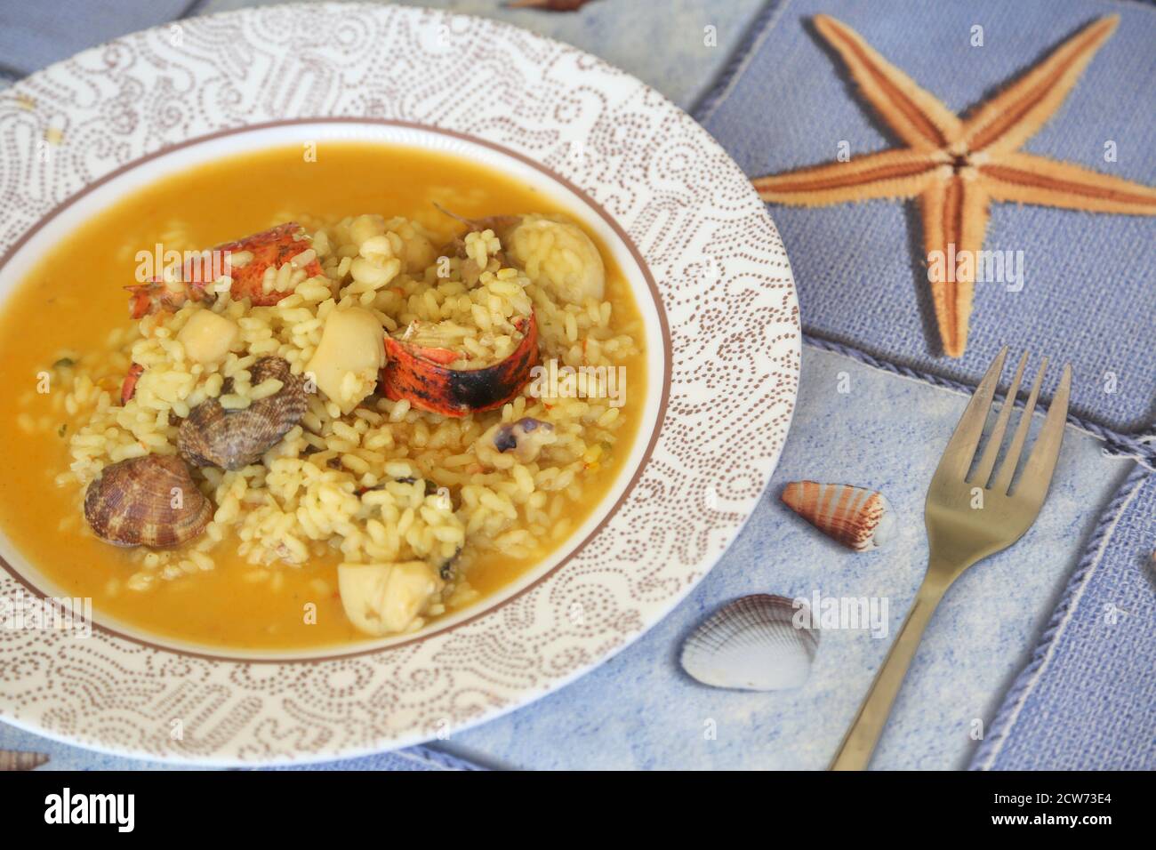 Seafood spanish rice with lobster and clams Stock Photo - Alamy