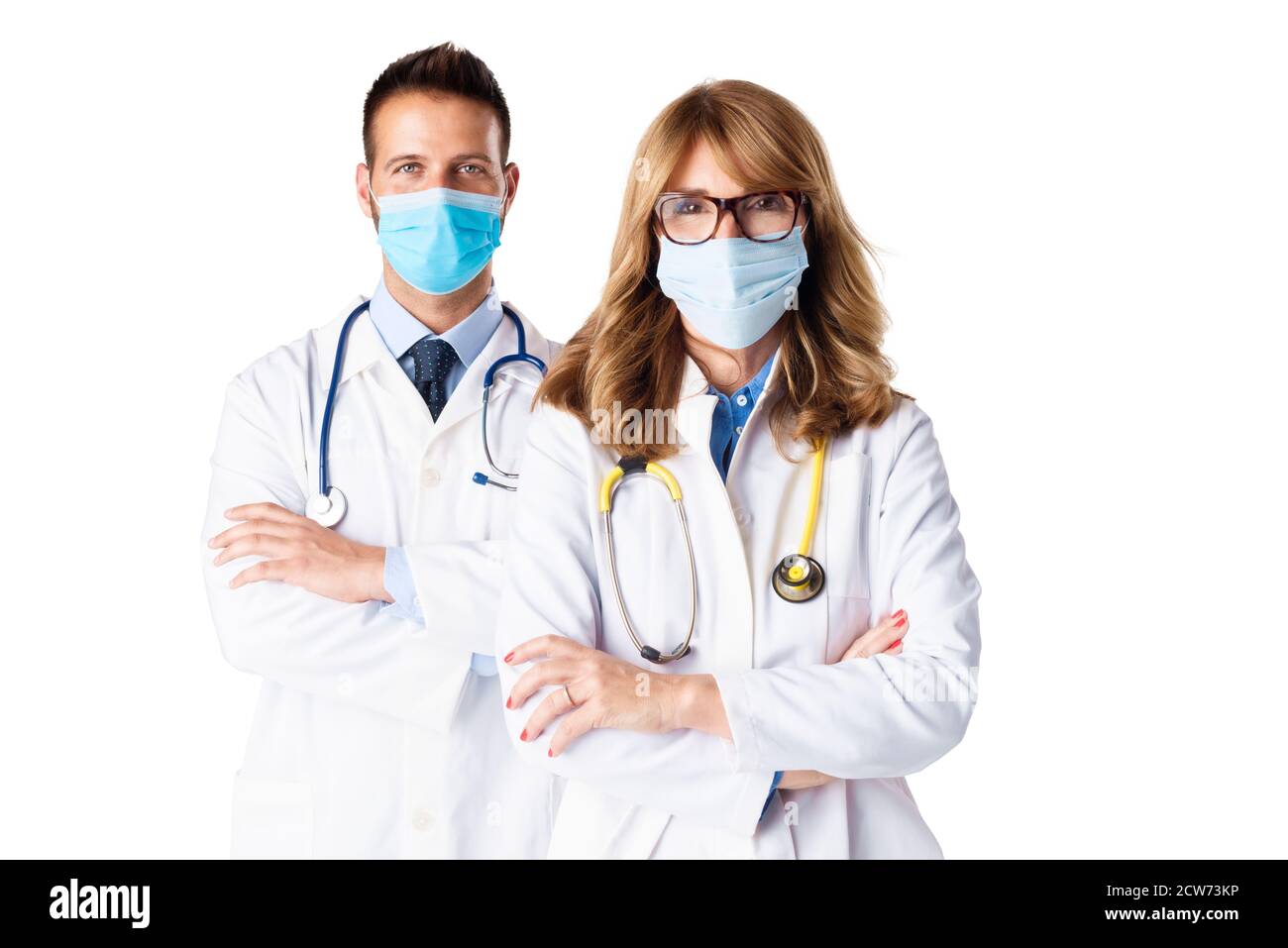 Shot of female and male doctors wearing face mask while standing ...
