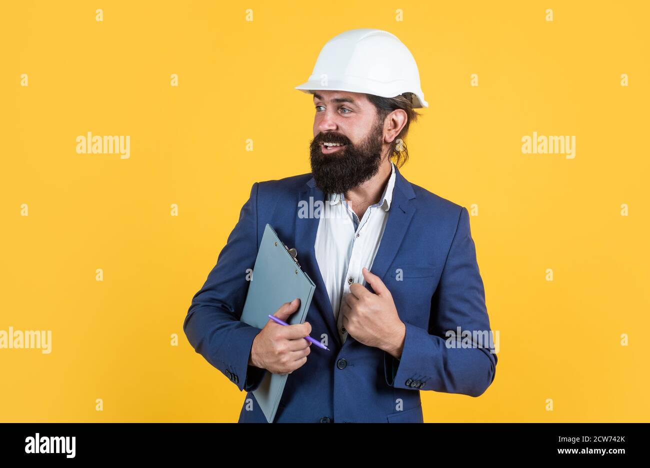 architecture and building. male builder wearing formal suit and helmet ...
