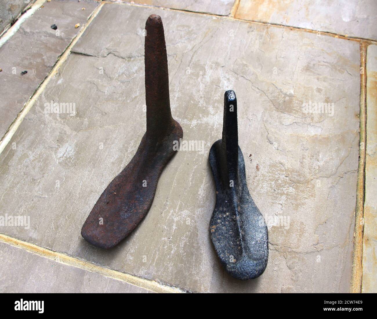 Photo of a Pair of different size cobblers iron shoe lasts standing on ...