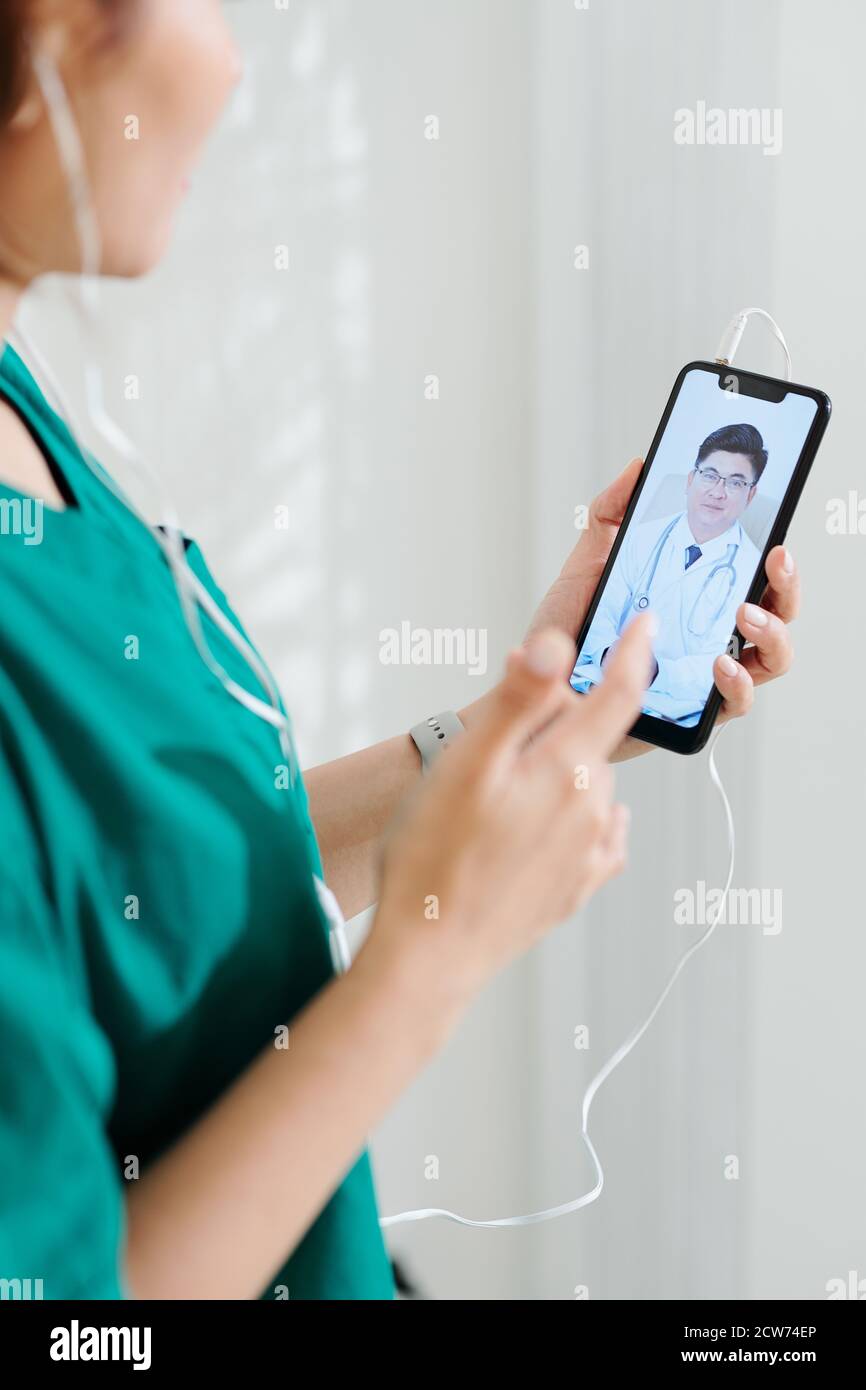 Doctor video calling Stock Photo - Alamy