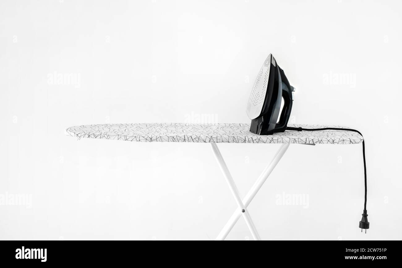 iron on ironing board against white wall background. High quality ...