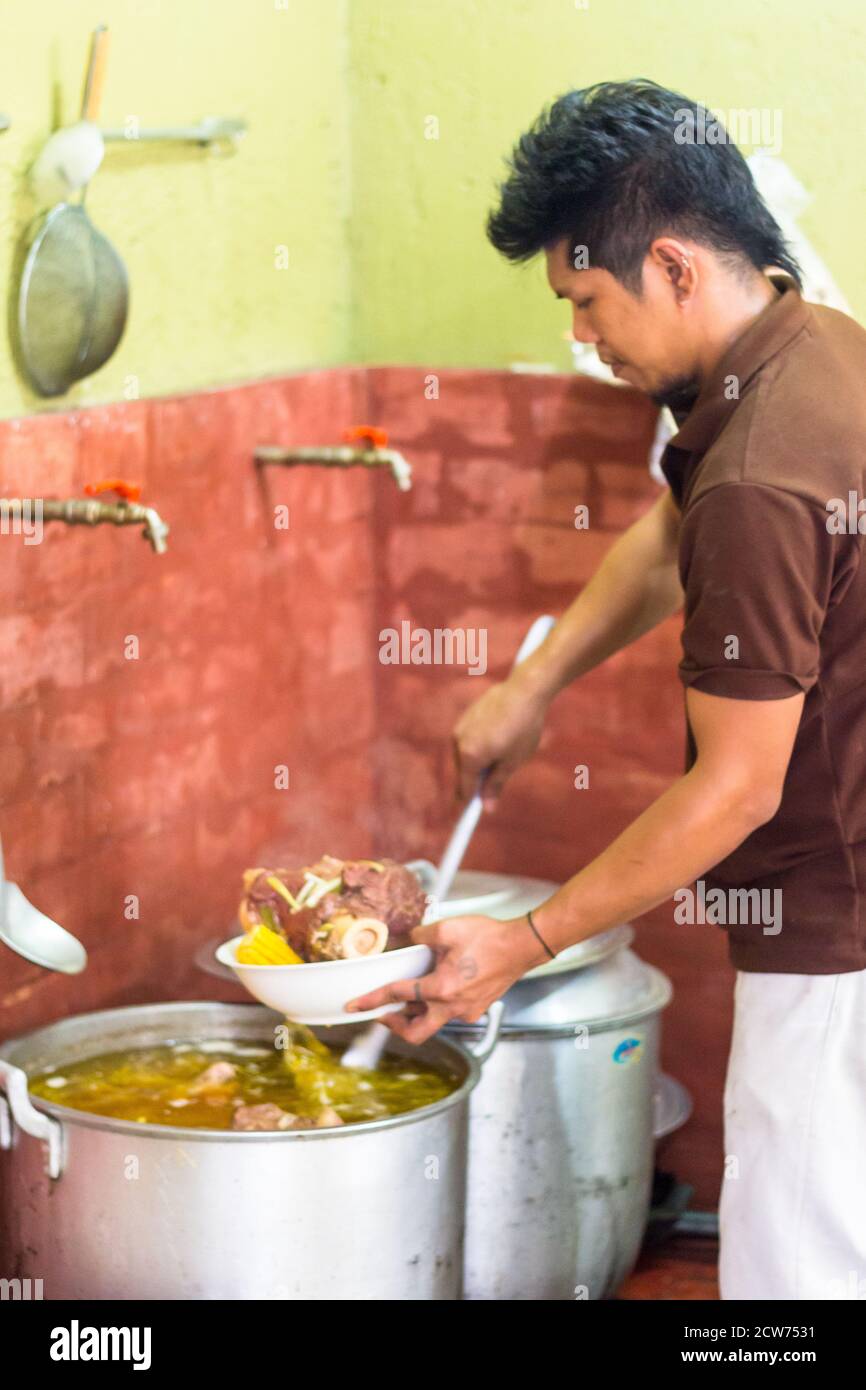 A Filipino cook preparing pochero, a popular beef stew dish Stock Photo ...